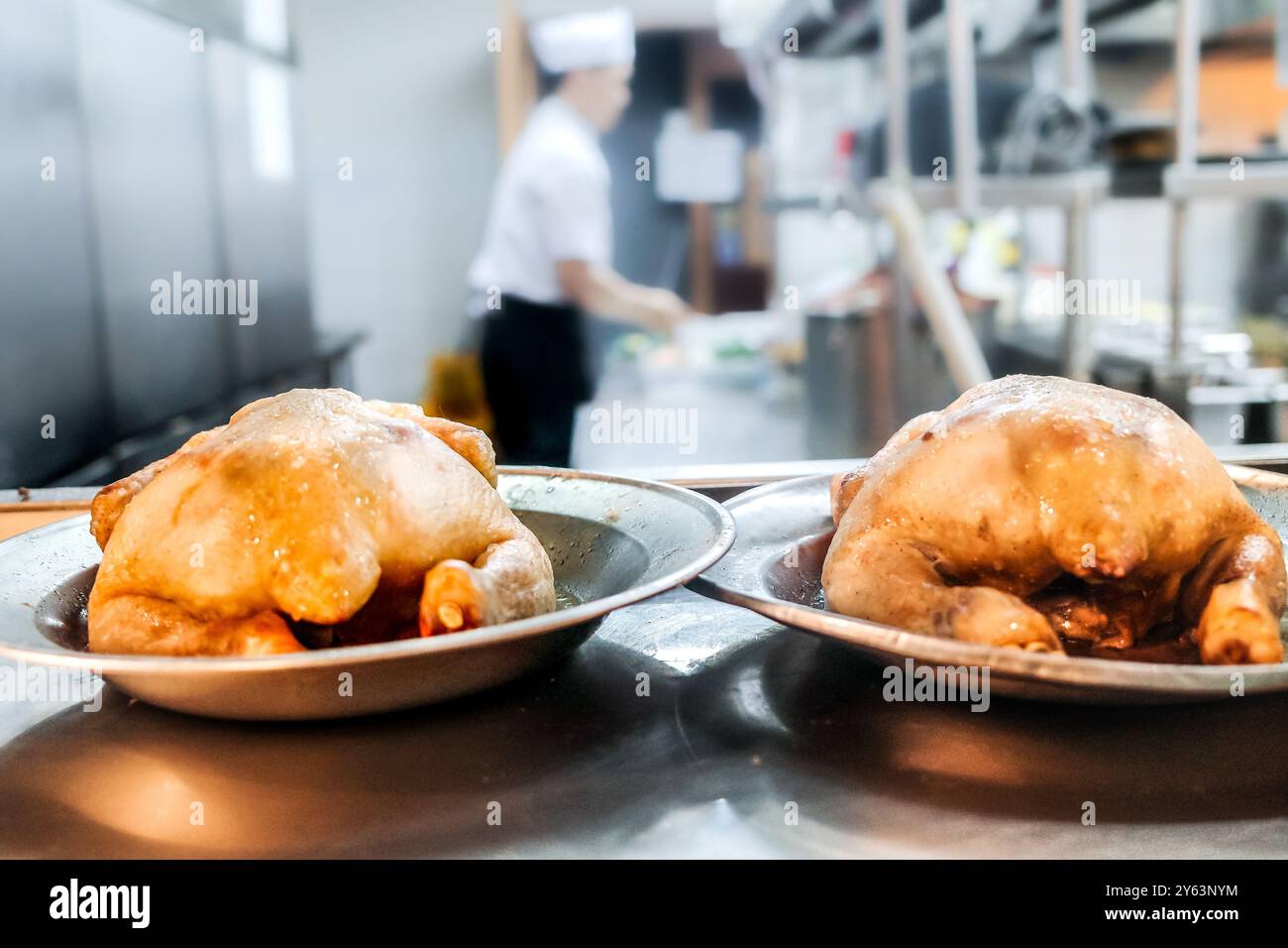 Chicken meat menu prepared in the kitchen of a restaurant with chef and ...