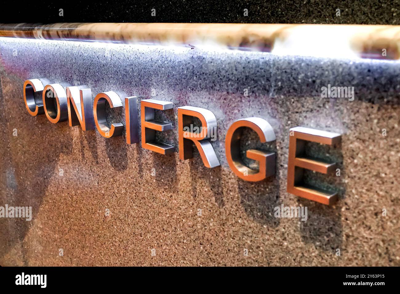 Concierge sign at the reception counter of a hotel Stock Photo - Alamy
