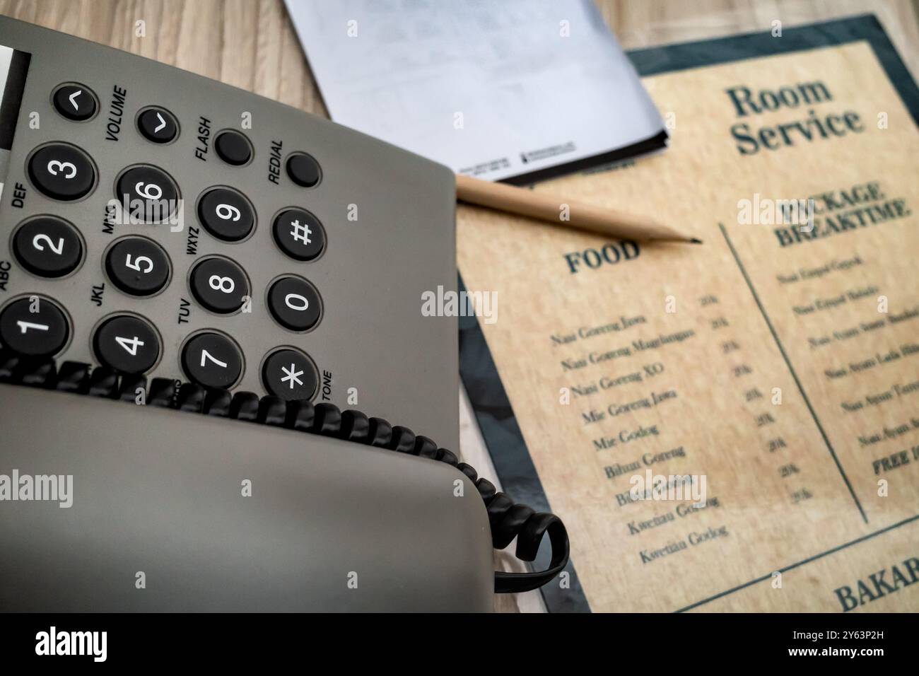 Room service menu and a phone line at the hotel Stock Photo - Alamy