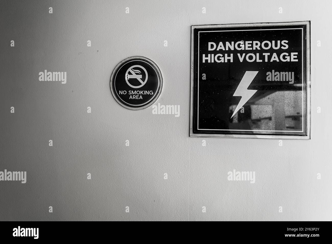 Electrical and smoking warning sign on the wall Stock Photo - Alamy
