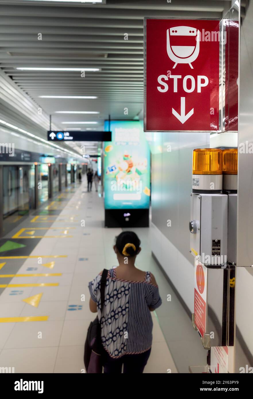 Train stop sign placed near the emergency panel at city subway station ...