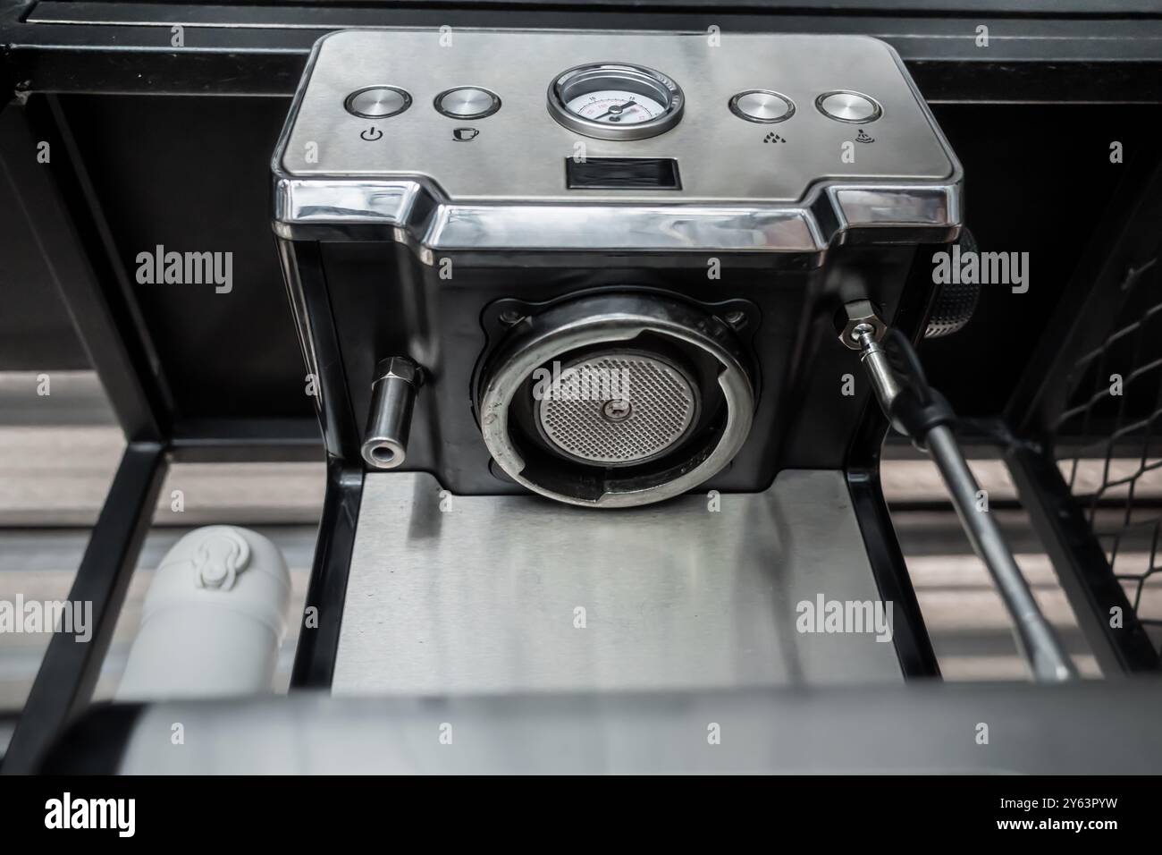 Closeup details bottom view of clean modern coffee espresso machine in ...
