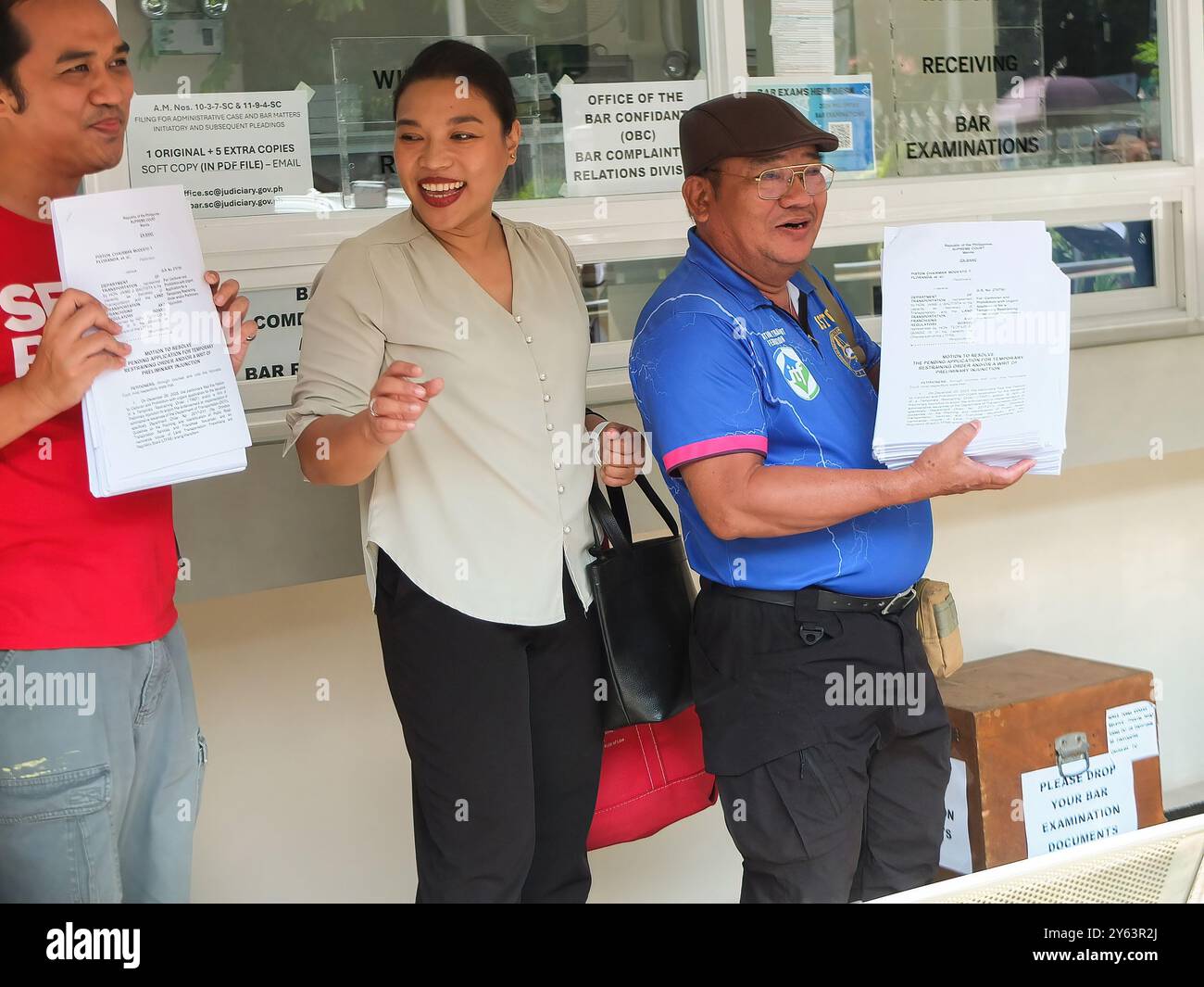 Lawyer Kristina Conti (L), President Mody Floranda (R), and a supporter ...