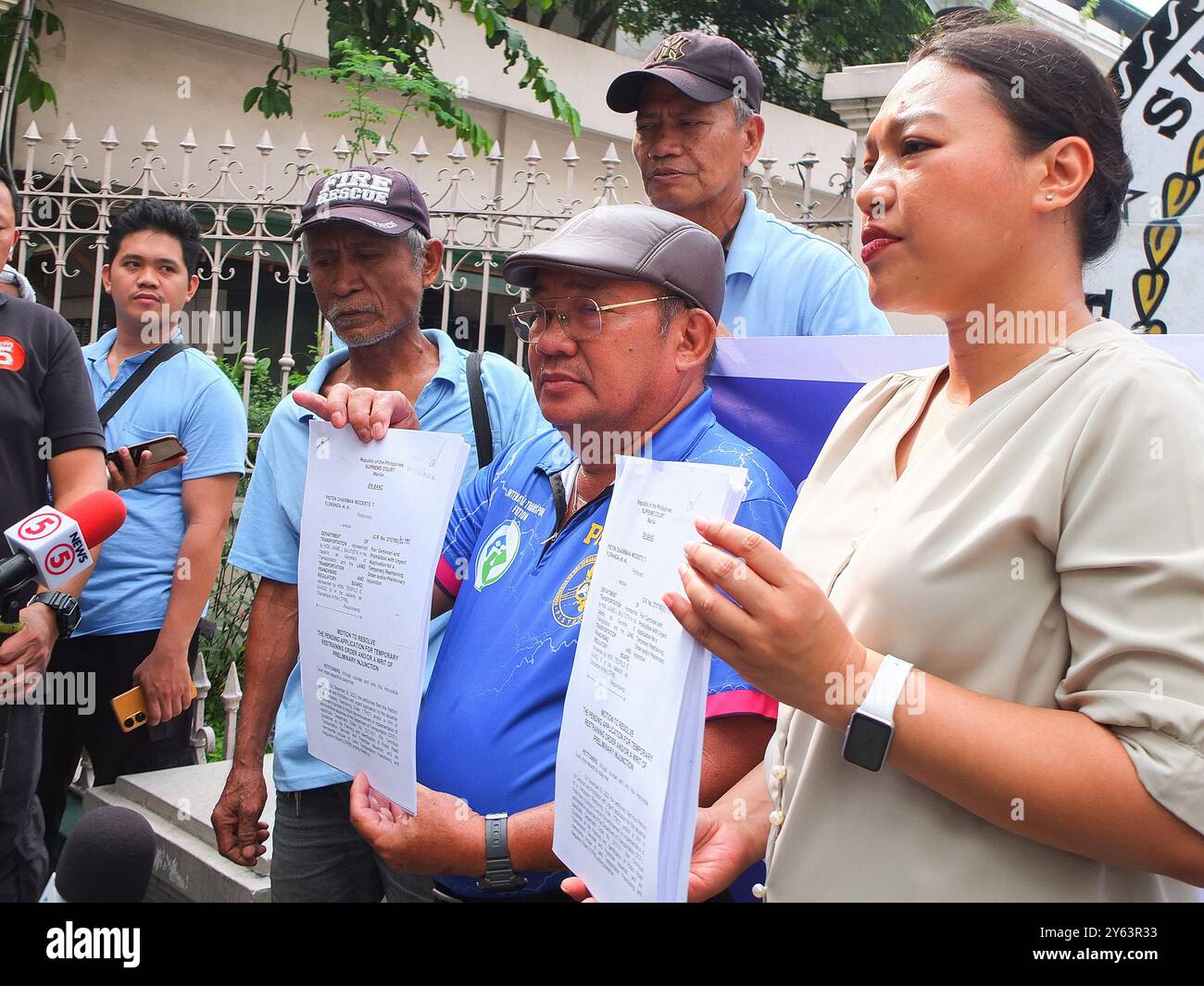 In front of the Media, Mody Floranda of PISTON and Kristina Conti hold ...