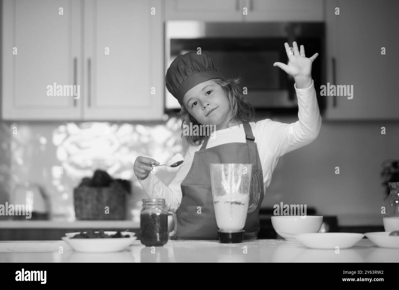 Kid cooking. Funny little kid chef cook wearing uniform cook cap and ...