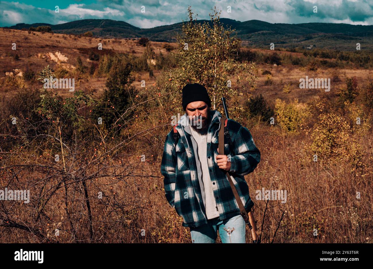 Hunter with shotgun gun on hunt. Hunter in the fall hunting season. Man ...