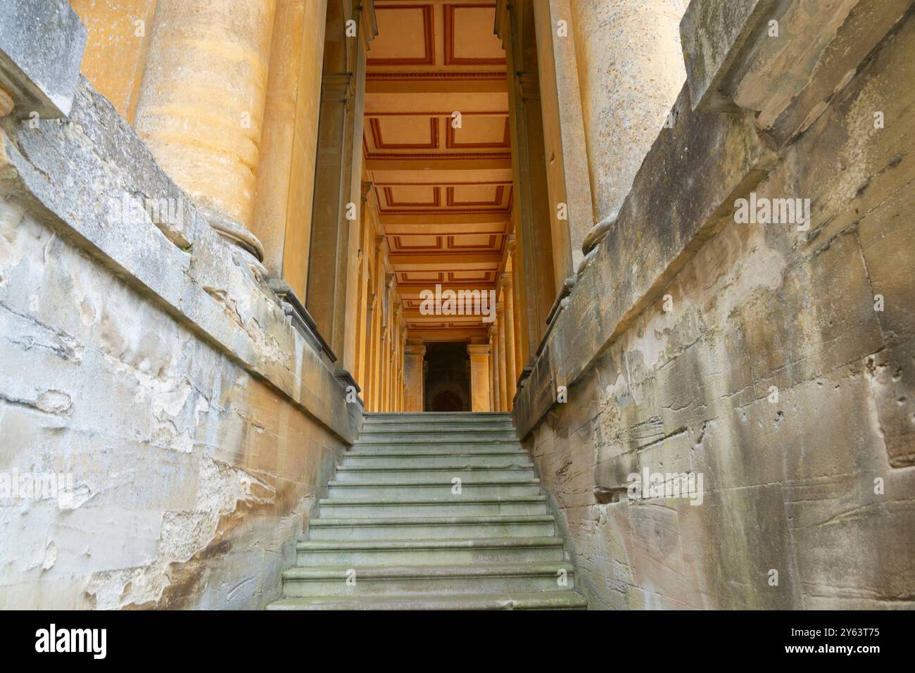 Steps leading upward between stone walls to hall Stock Photo - Alamy