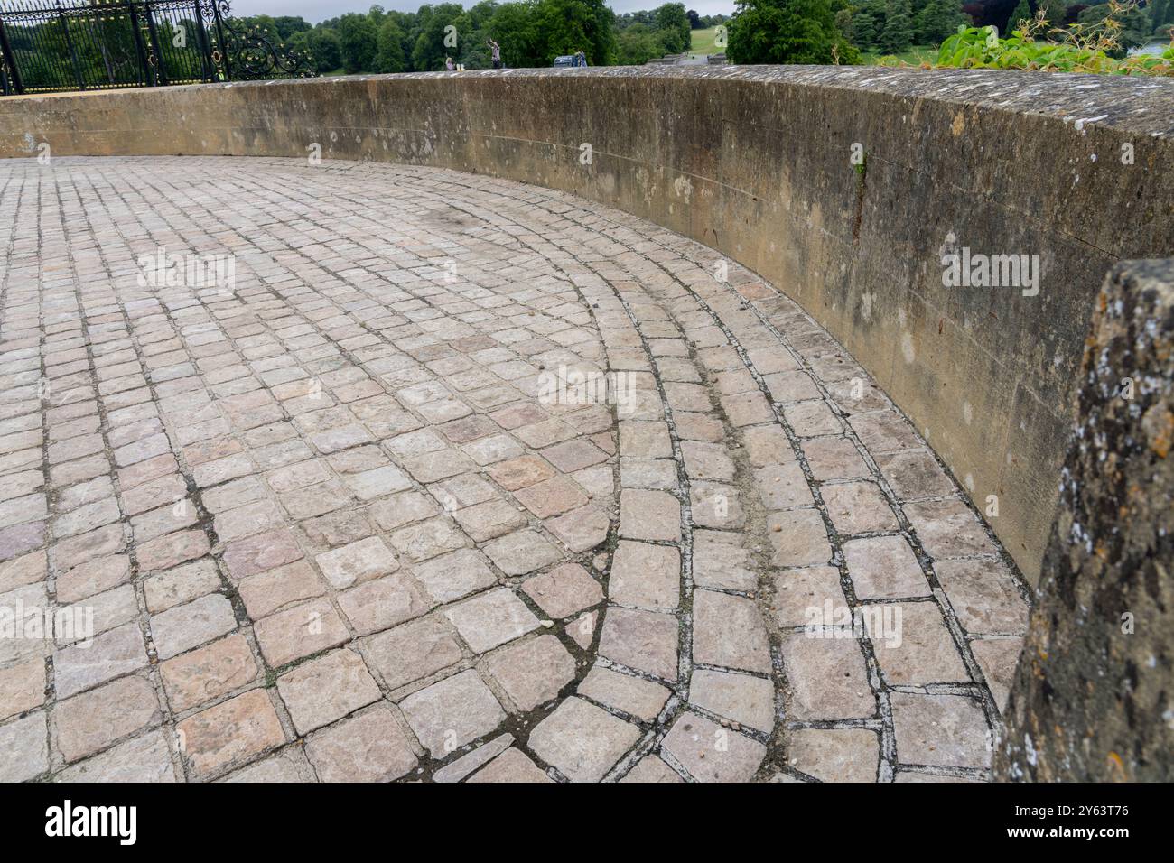 Stone wall surrounding patterned cobblestone paved area Stock Photo - Alamy