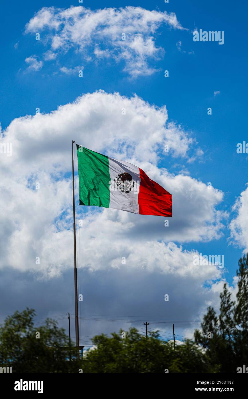 Mexican flag waving in the blue sky with clouds (Photo By Luis ...