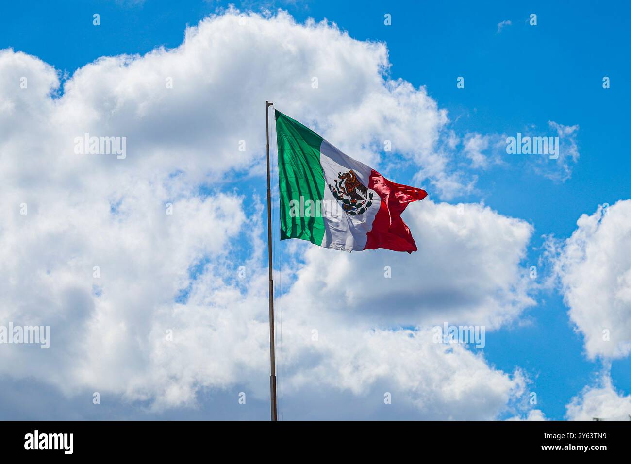 Mexican flag waving in the blue sky with clouds (Photo By Luis ...