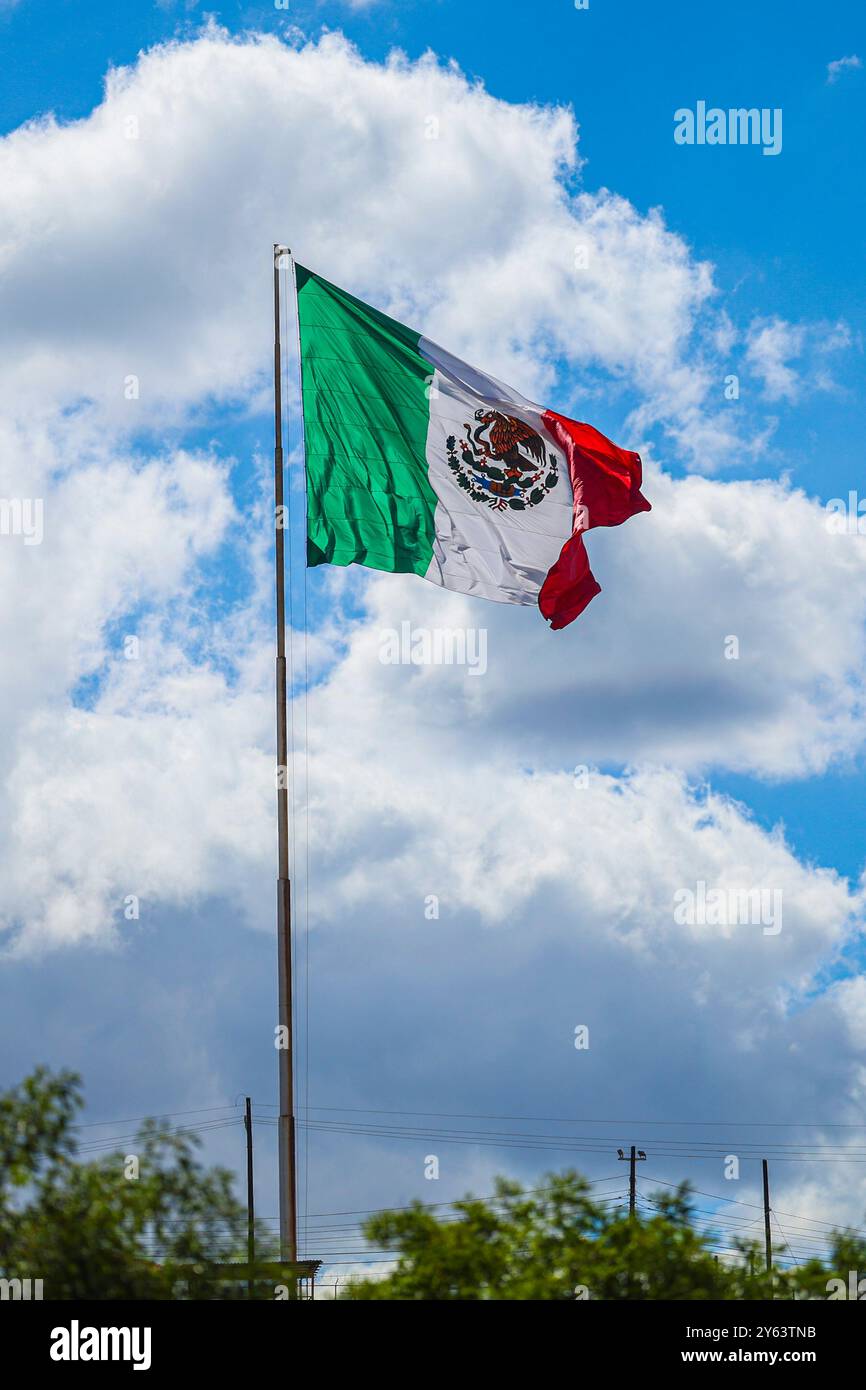 Mexican flag waving in the blue sky with clouds (Photo By Luis ...