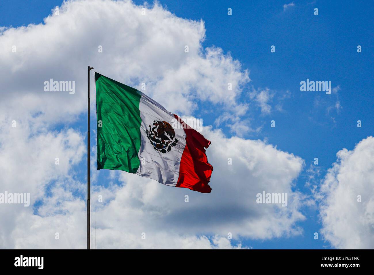 Mexican flag waving in the blue sky with clouds (Photo By Luis ...