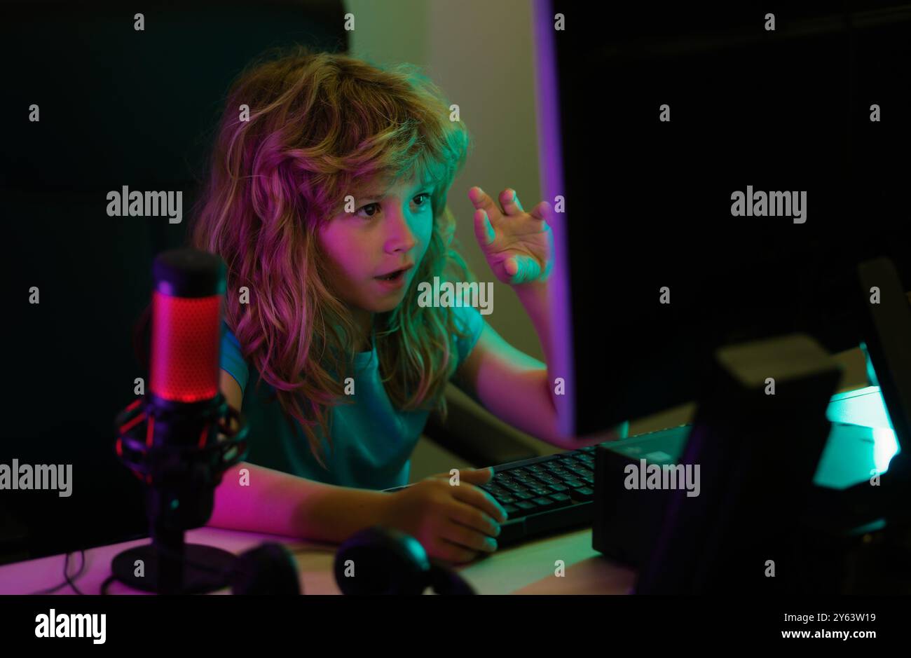 Little kid using desktop pc by night, child boy illuminated by the blue ...