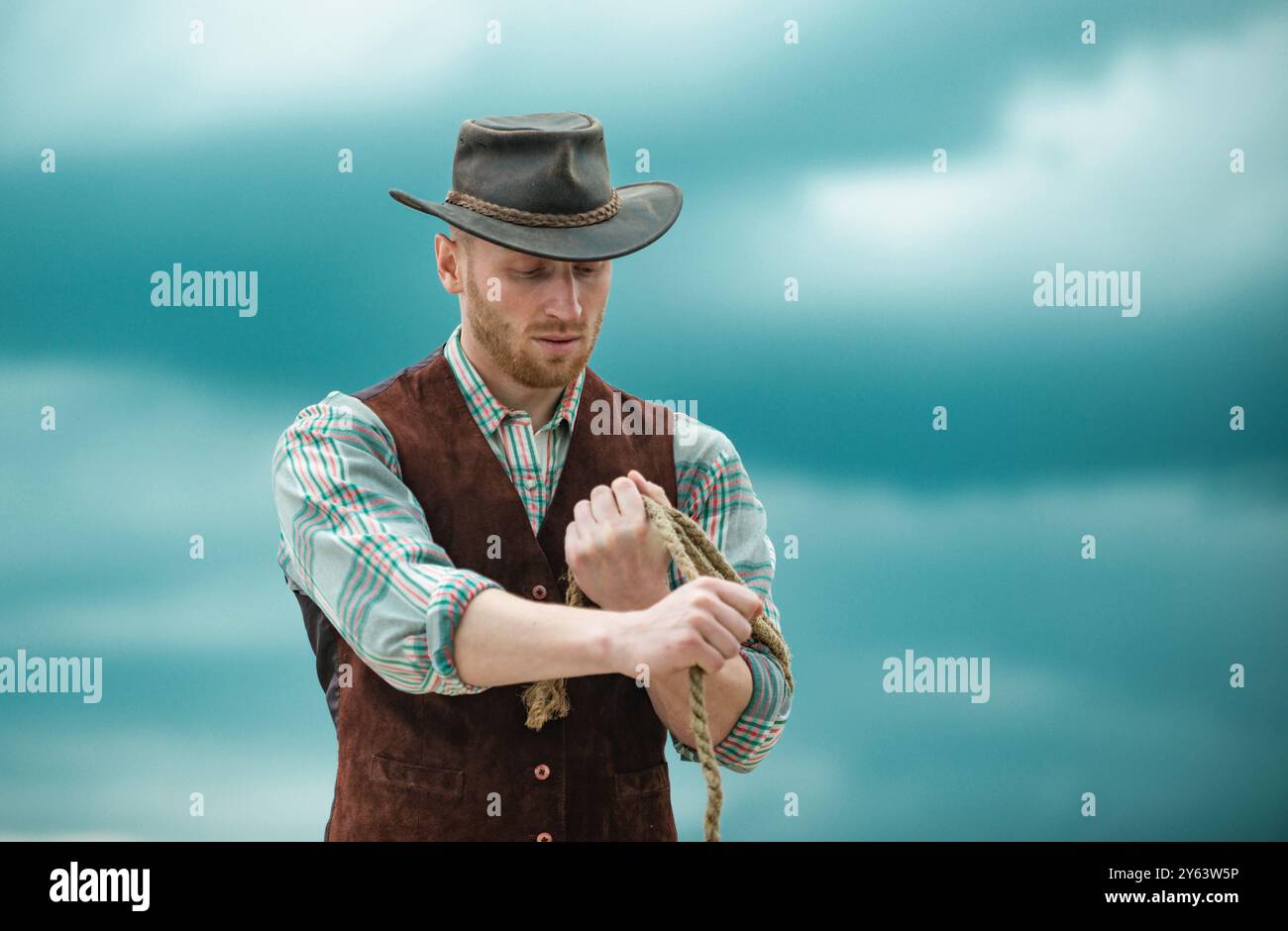 Cowboy farmer man in country side wearing western cowboy hat. American ...