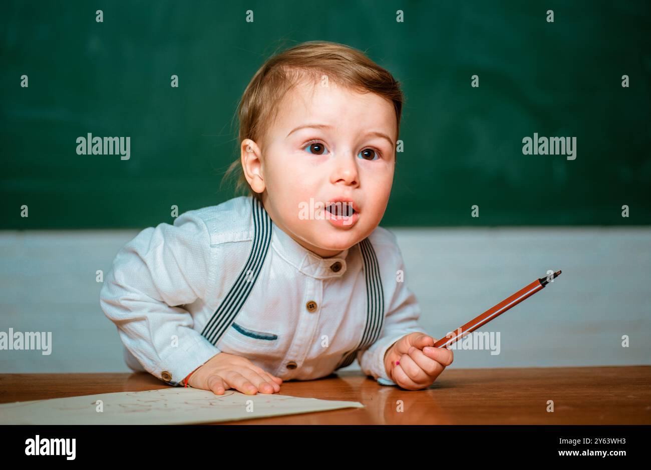 Little preschool at school lesson. Home study. Kid gets ready for ...