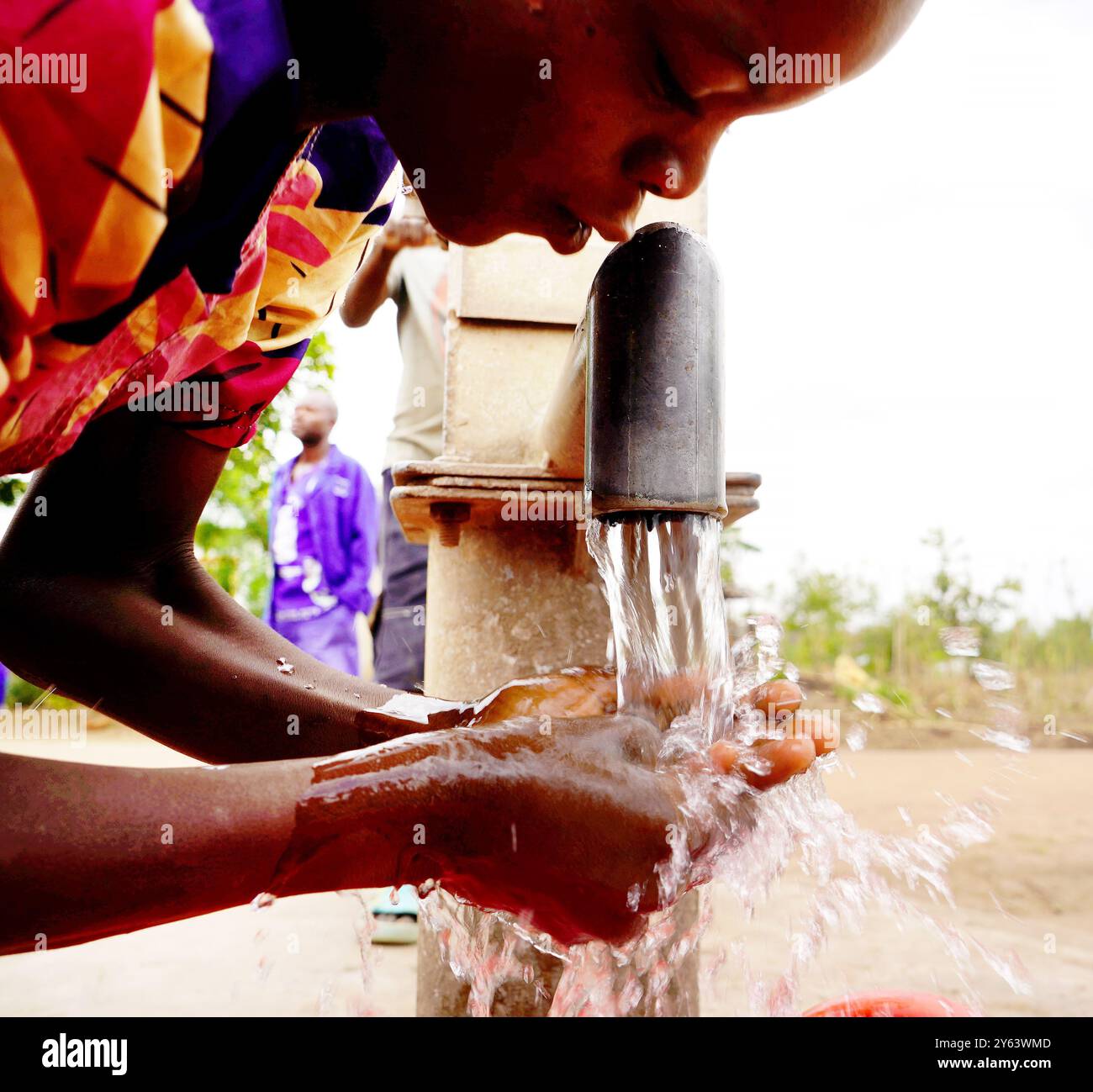 Matoso Village, Blantyre, Malawi -16 September 2024: A young child cups ...