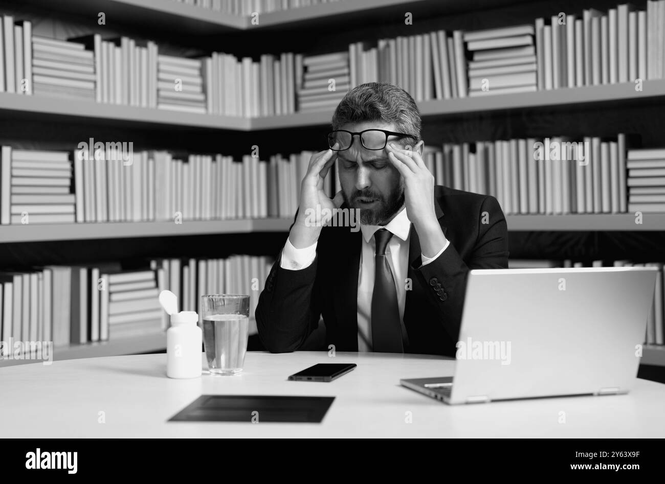Tired man suffering from headache after computer work, exhausted with ...