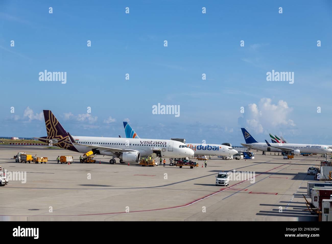 A busy airport scene featuring various aircraft on the tarmac ...