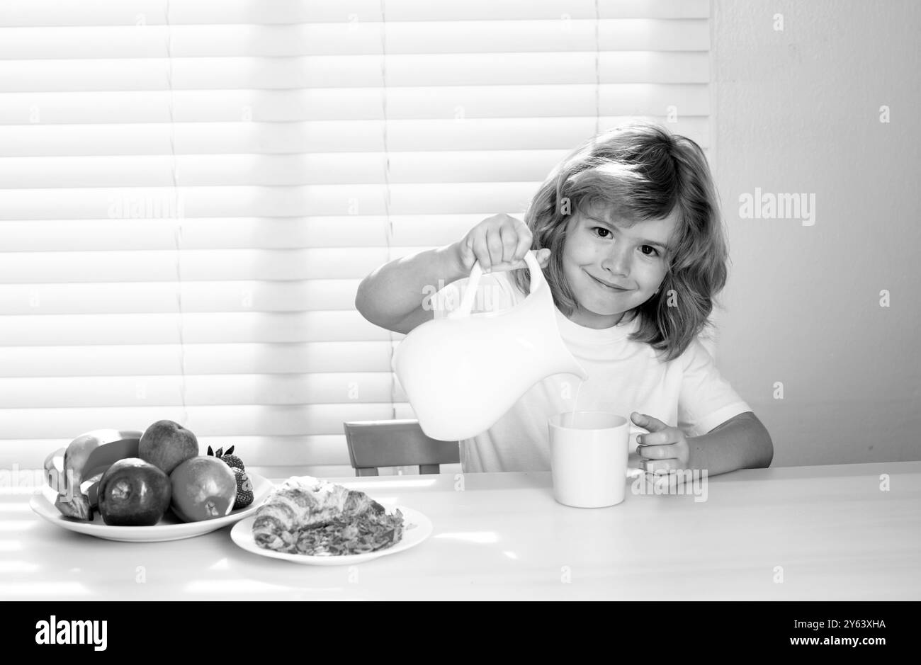 Fuuny little boy pouring whole cows milk for breakfast. Kid preteen boy ...