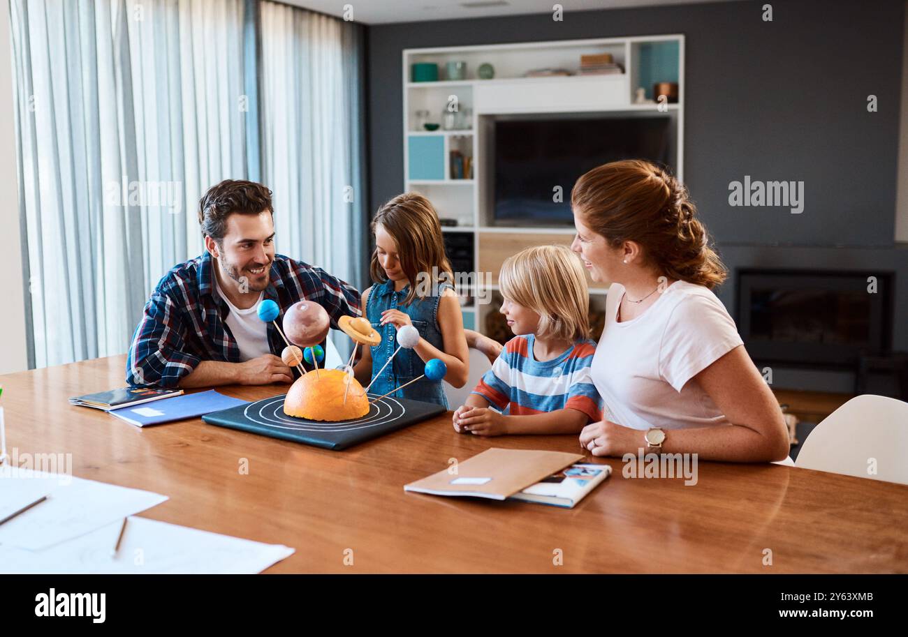 Parents, children and science project for study in home, building solar ...