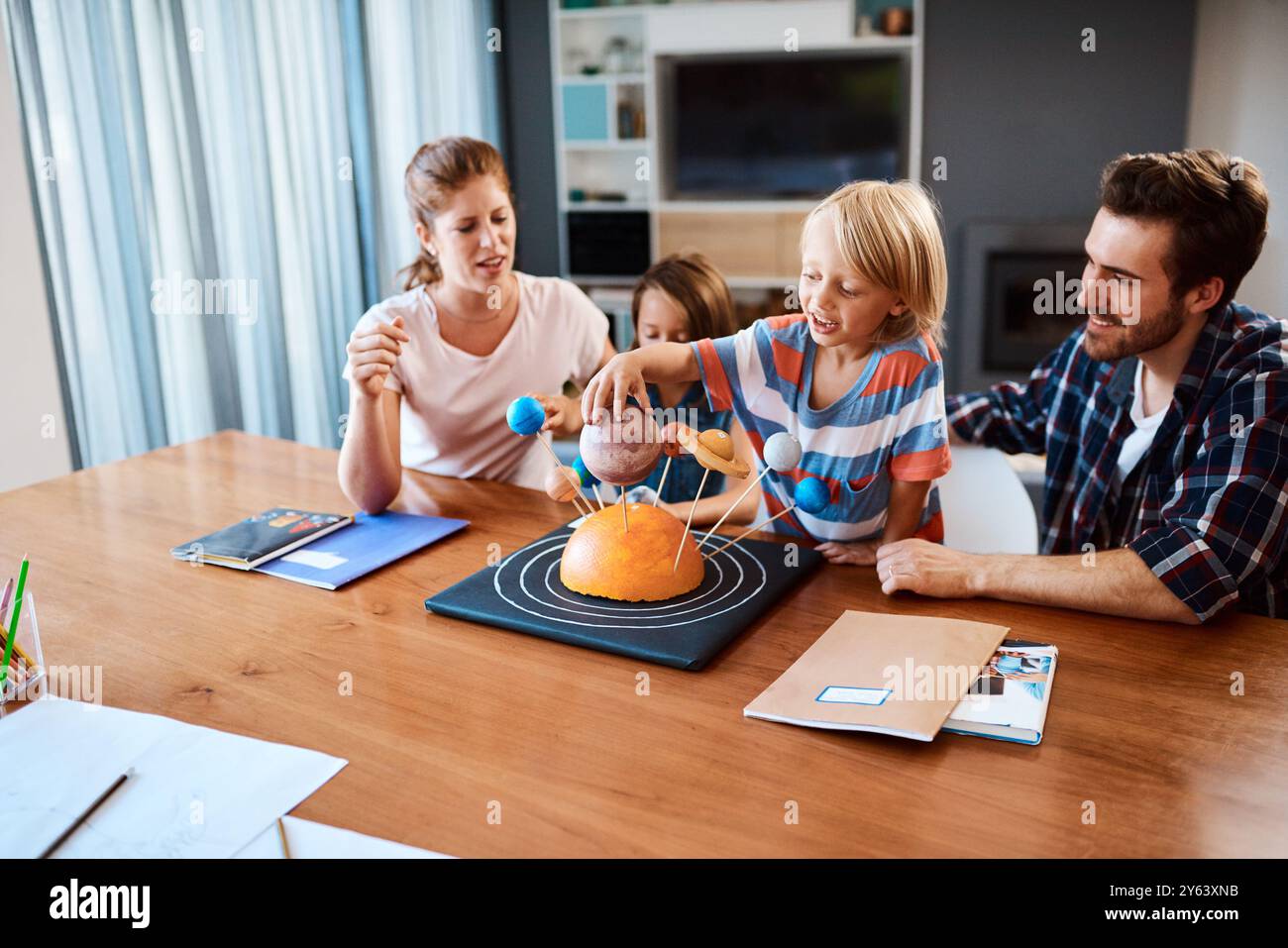 Parents, kids and science project for school in home, building solar ...