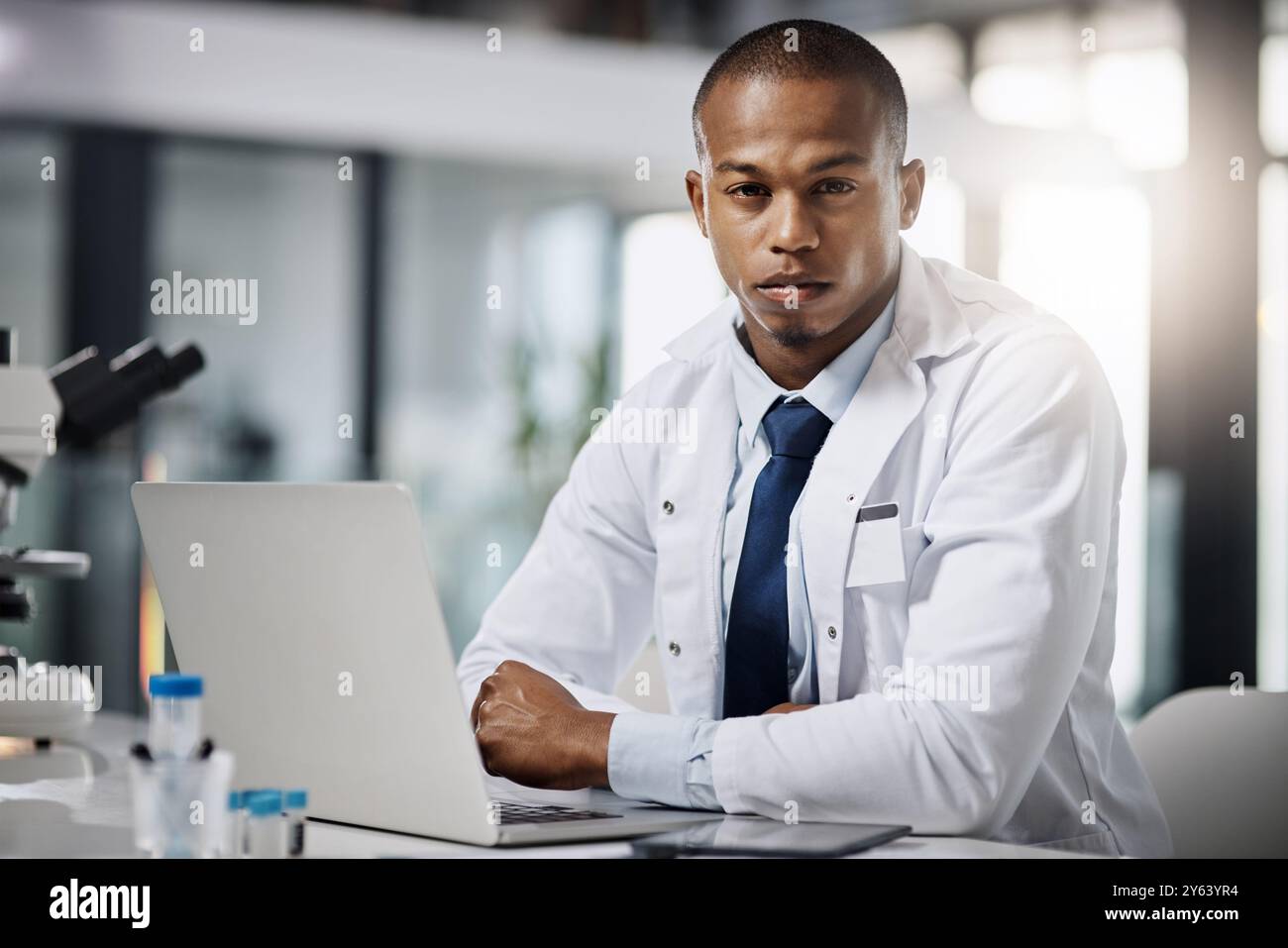 Black man, portrait and laptop in lab for science, innovation and ...
