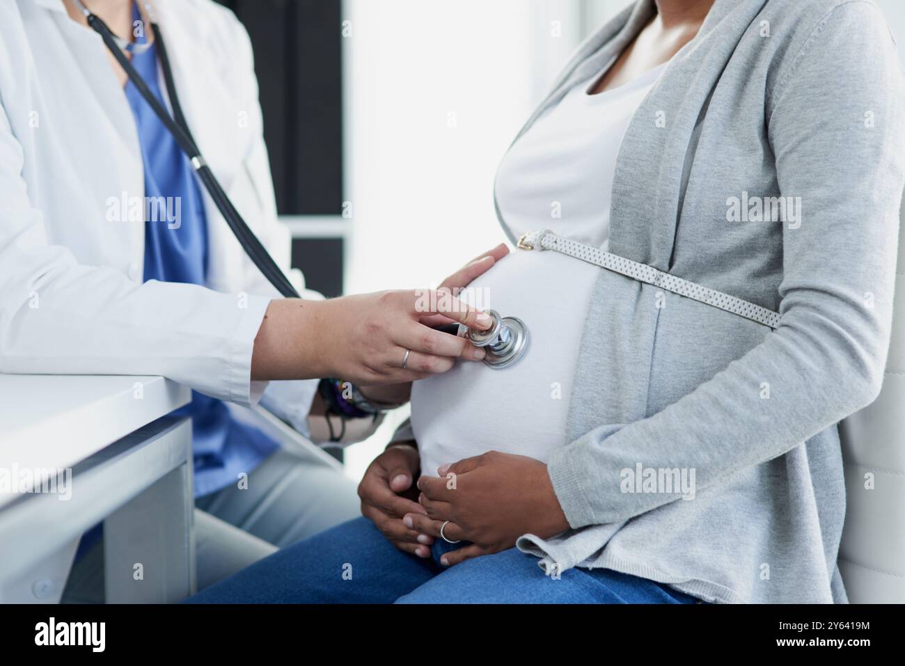 Healthcare, pregnant woman and doctor with stethoscope for listening ...