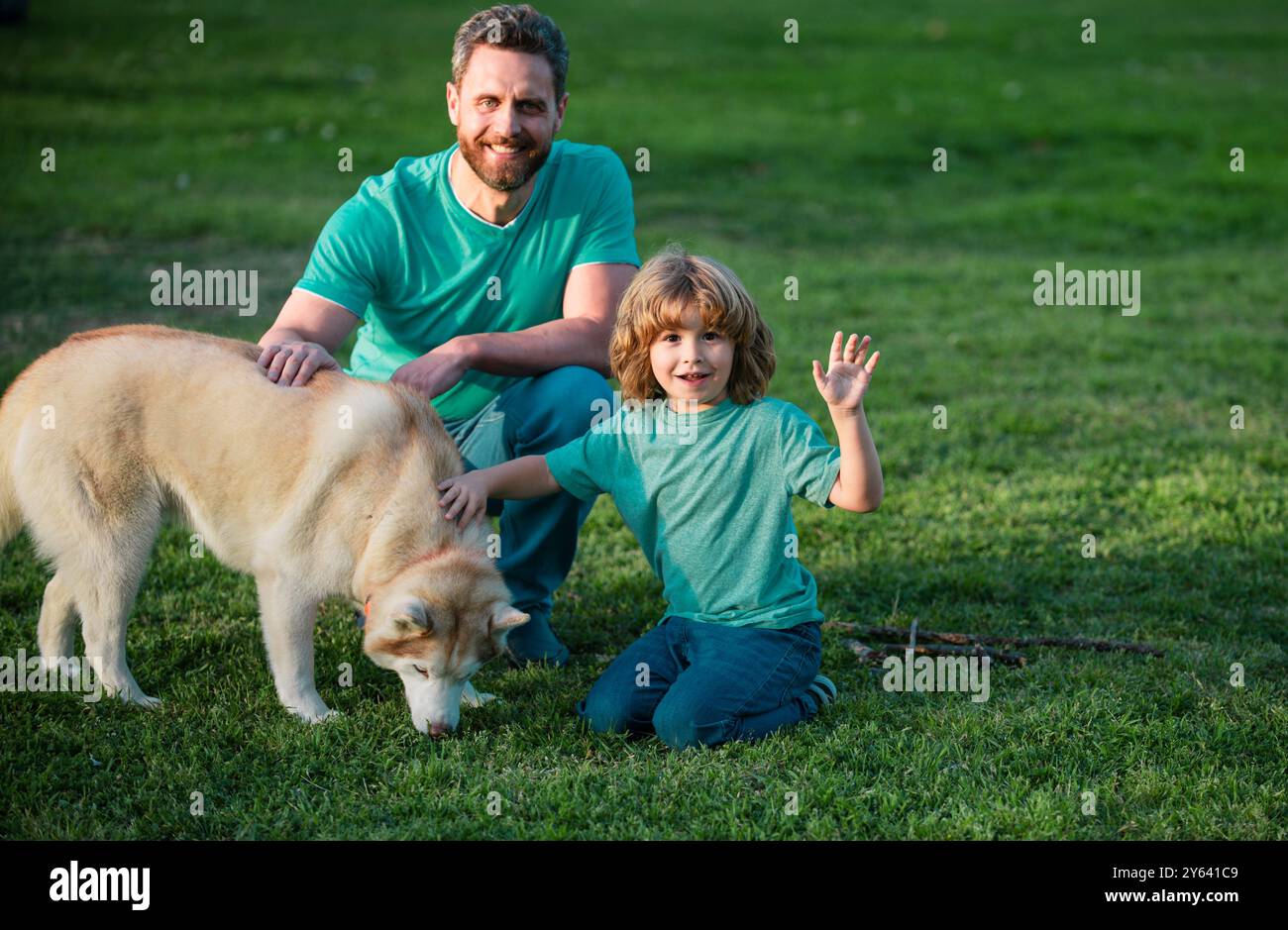Beautiful happy family is having fun with dog husky. Happy father and ...