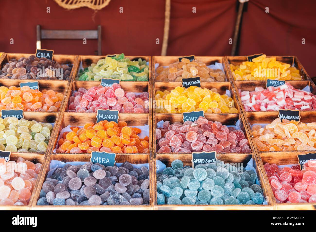 A colorful display of various types of sugar-coated gummy candies in ...