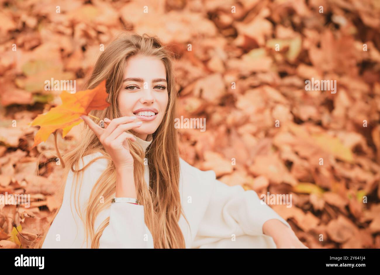 Autumn trend. Beautiful woman fashion model having fun in fall park outdoors Stock Photo - Alamy