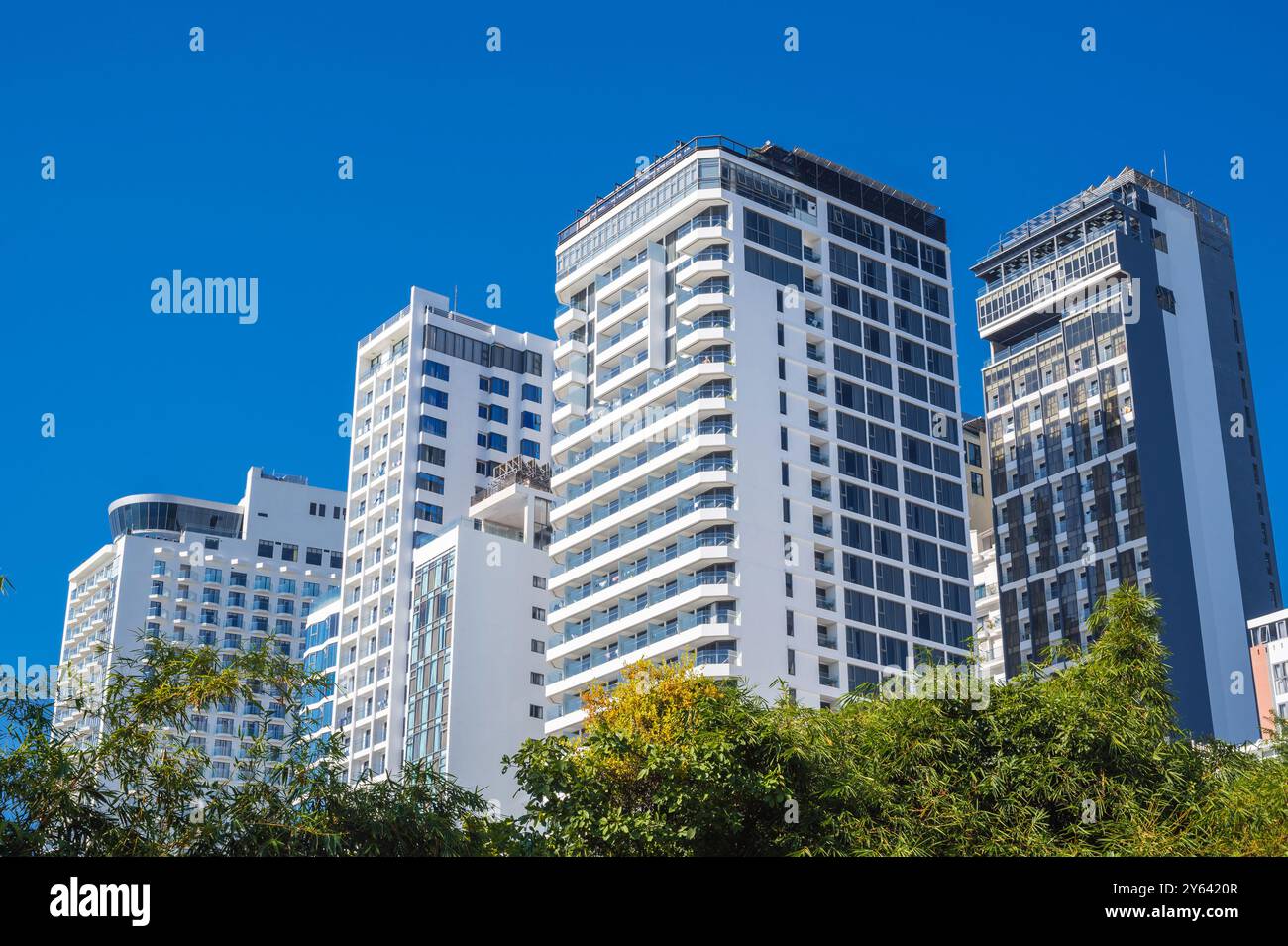 facades of tall modern hotels and skyscrapers against the blue sky in ...