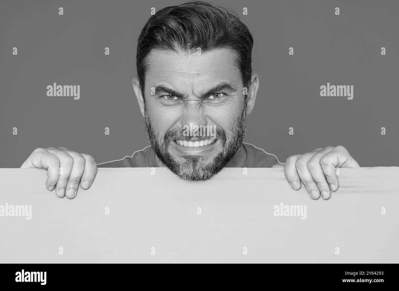 Angry close up face of man with blank banner ad, posing isolated over ...