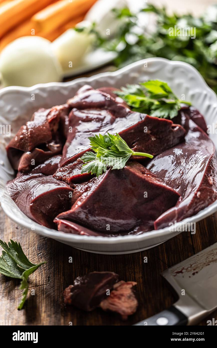 Sliced beef liver in a white bowl, ready to cook Stock Photo - Alamy