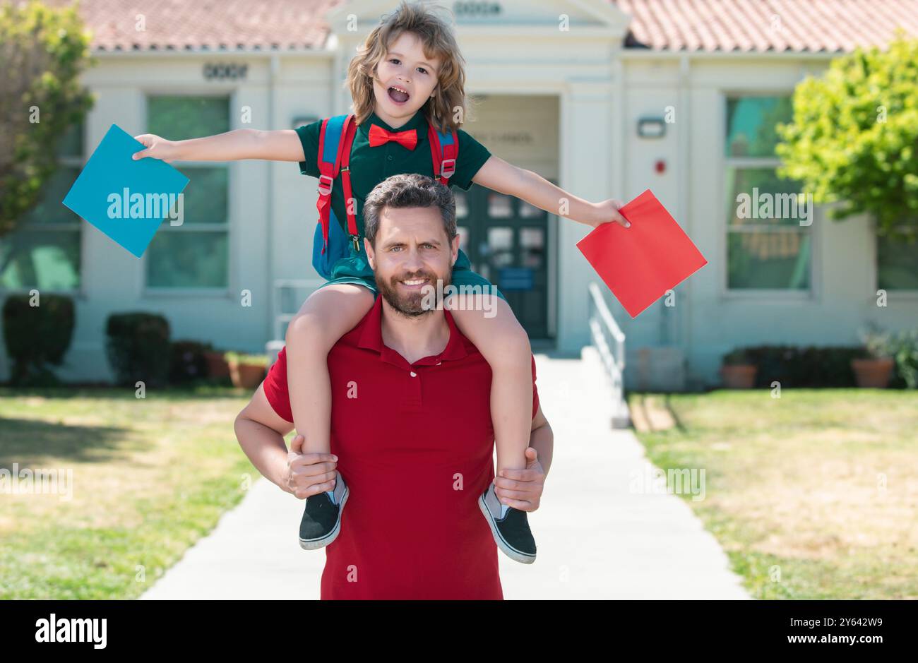 Father and son piggyback ride come back from school. School, family ...