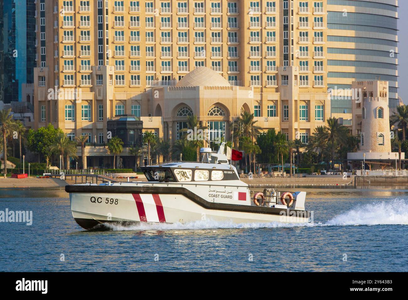 A motorboat of the Qatari coast guard cruising quietly along the ...