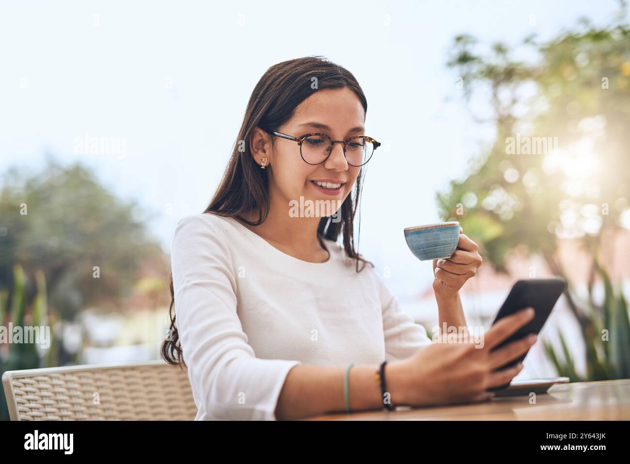 Woman, outdoor and phone for texting at cafe, surfing social media and ...