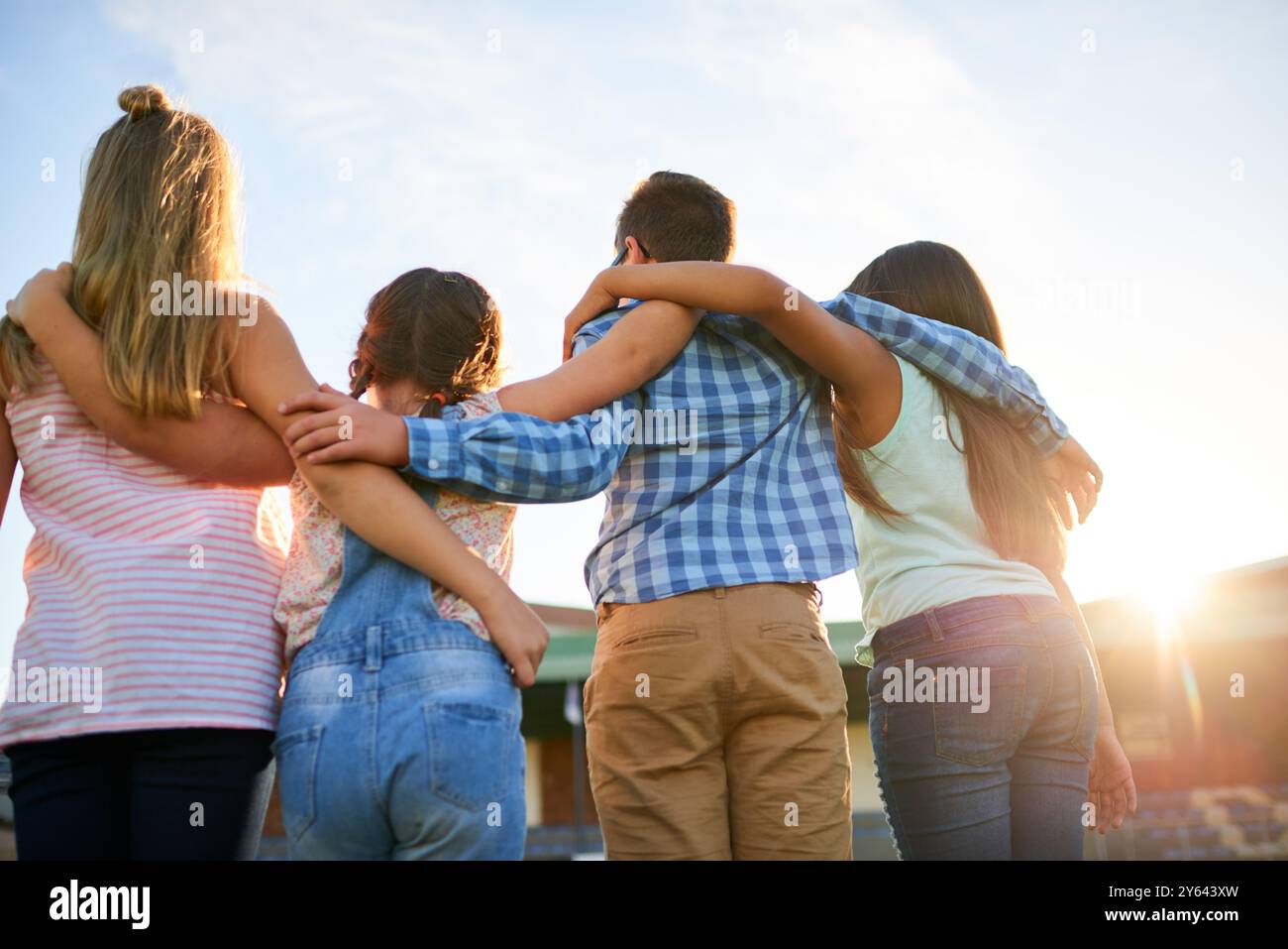 Hug, morning and back of children in park for support, friendship and ...