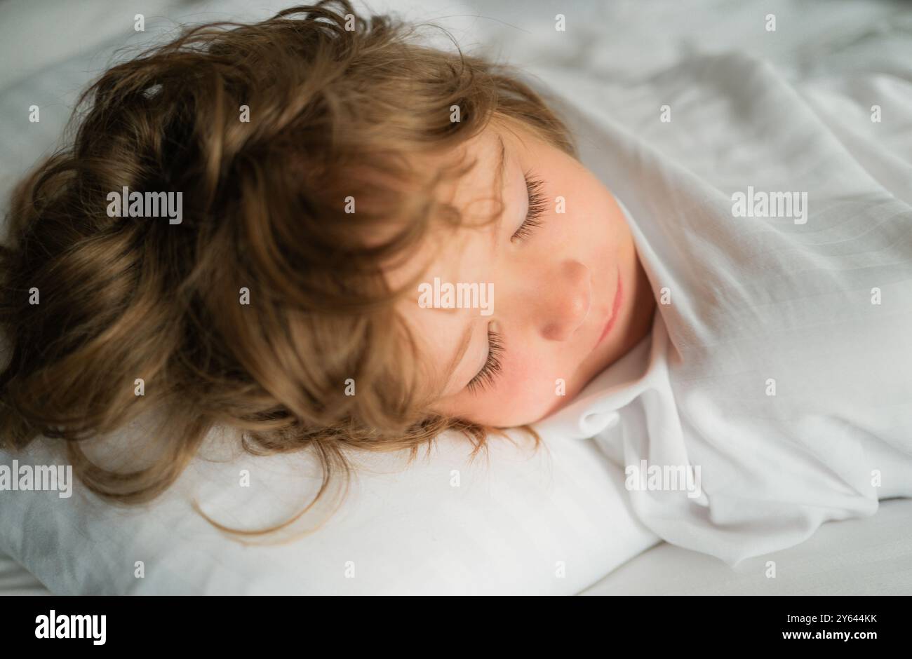 Calm adorable kids lying on soft pillows. Kids sleeping. Six years old ...