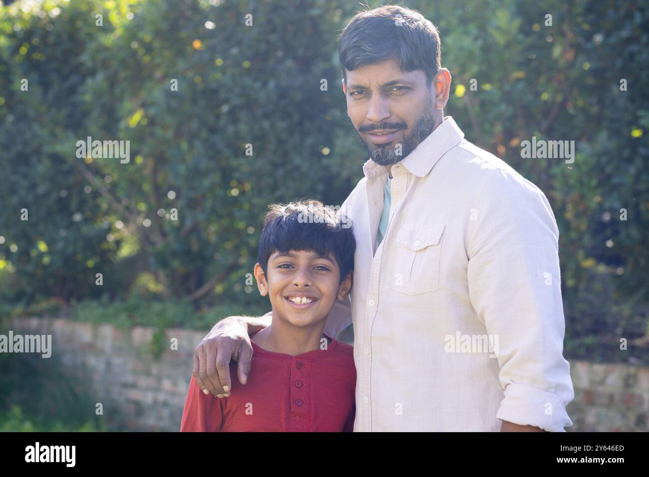indian father and young son smiling together outdoors, enjoying quality ...