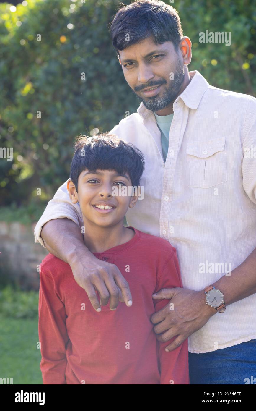 indian father and young son smiling and bonding outdoors in park Stock ...