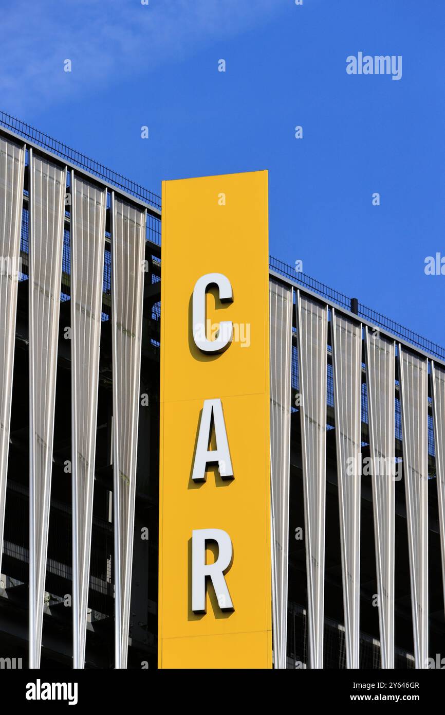 Yellow vertical car park sign with white letters in close up mounted on ...