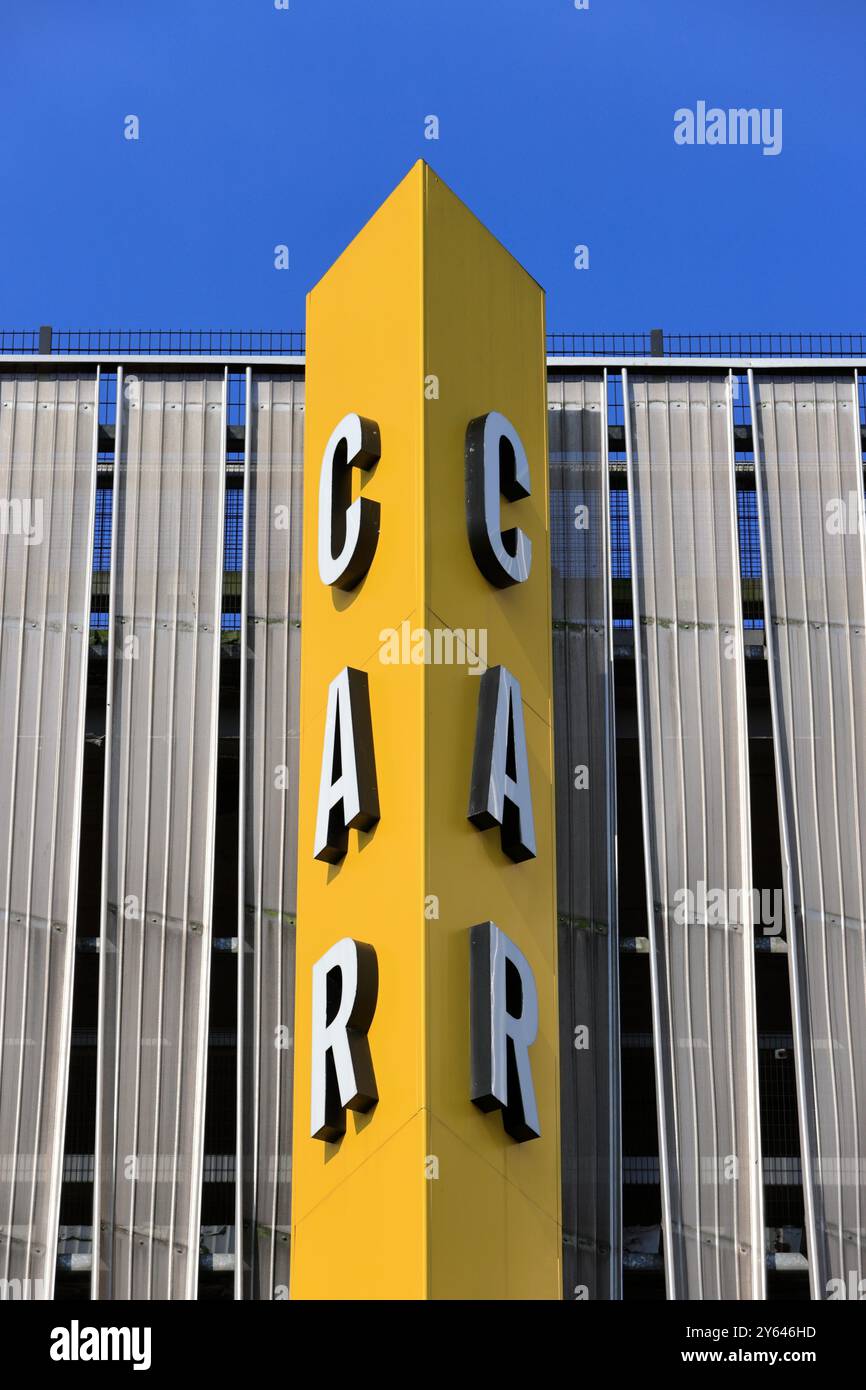 Yellow vertical car park sign with white letters in close up mounted on ...