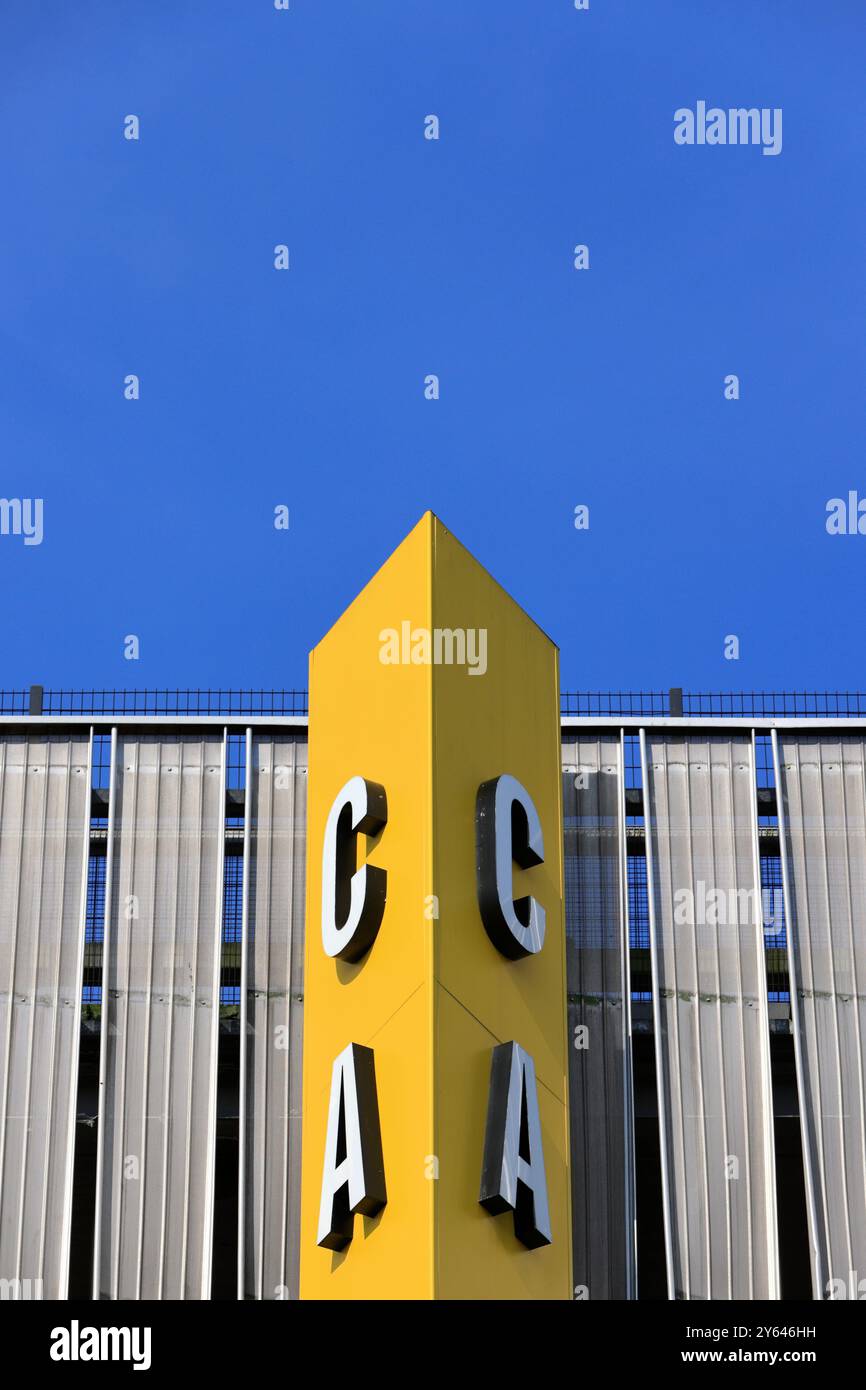 Yellow vertical car park sign with white letters in close up mounted on ...