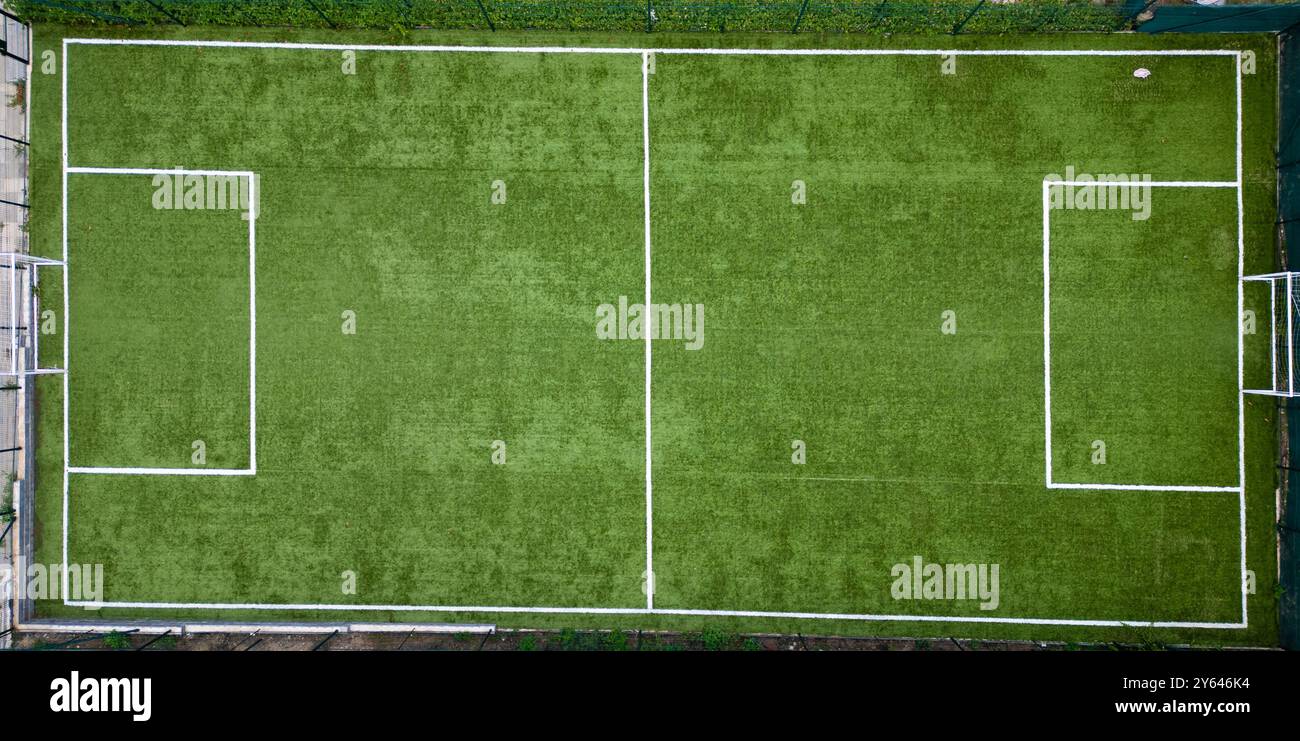 Aerial view of an empty soccer field with well-defined white lines on ...