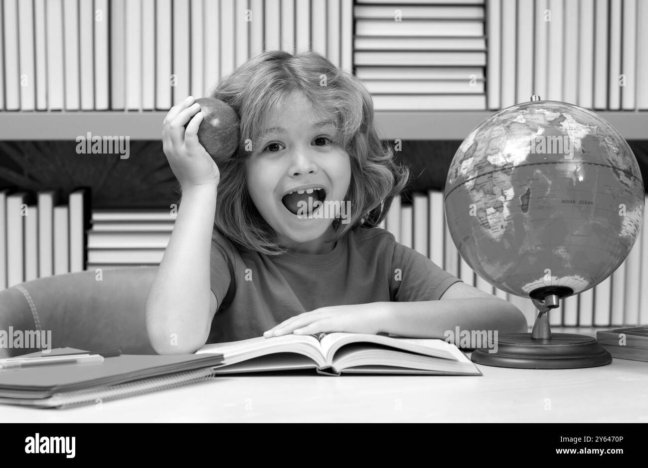 School boy with books and apple in library. Nerd pupil. Clever child ...