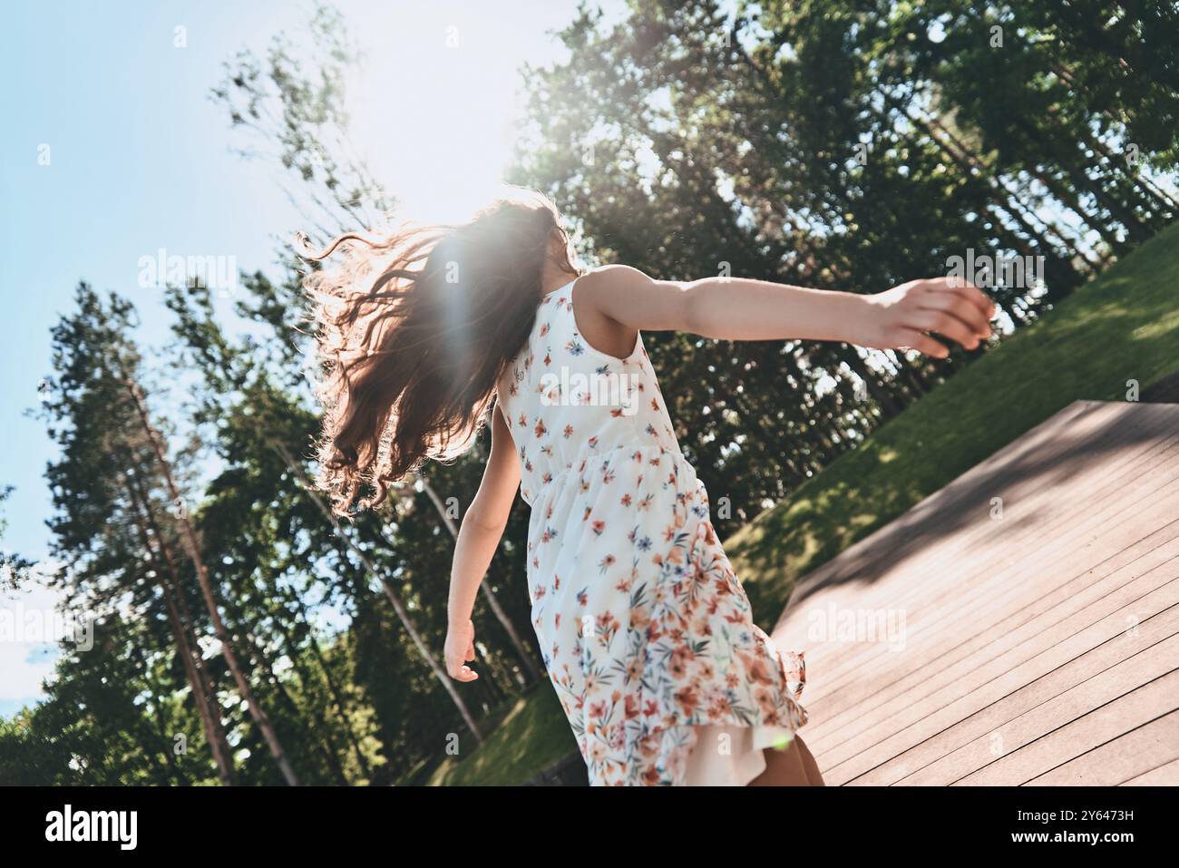 Summer fun. Rear view of little girl running while spending time ...