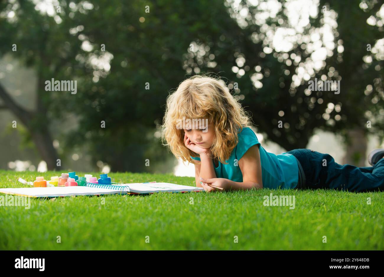 Child drawing. Portrait of smiling happy kid enjoying art and craft ...