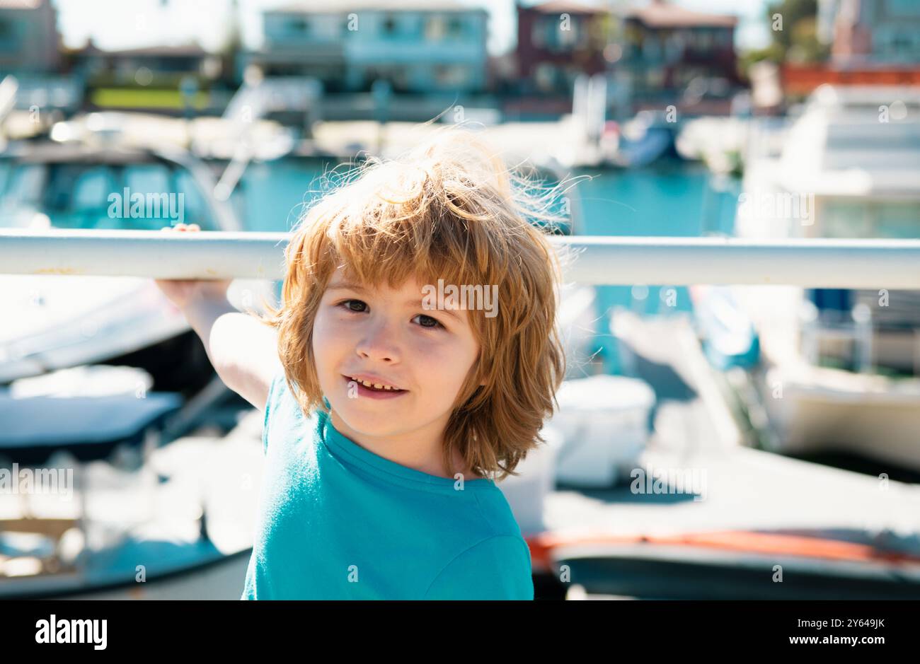 Berth near sea. Little boy in yacht port. Summer vacation. Traveling by ...