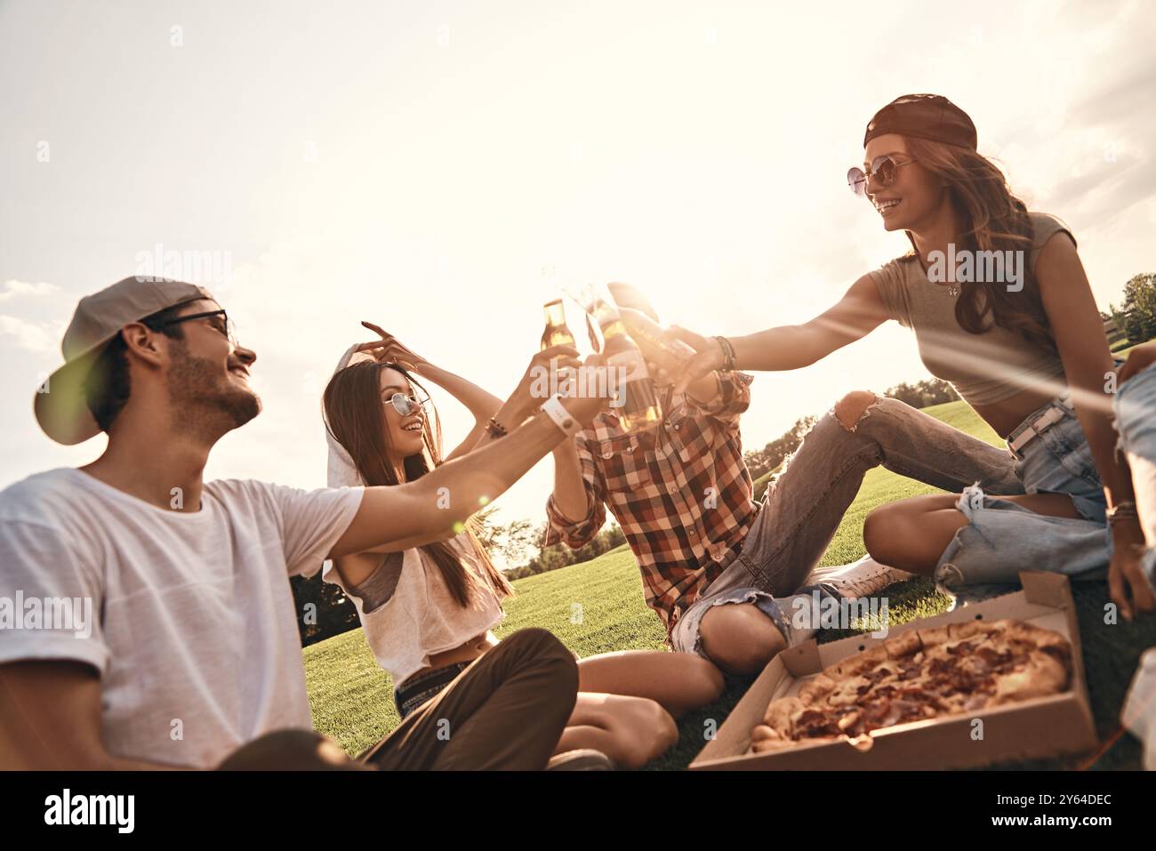 Cheers to friends! Group of young smiling people in casual wear ...
