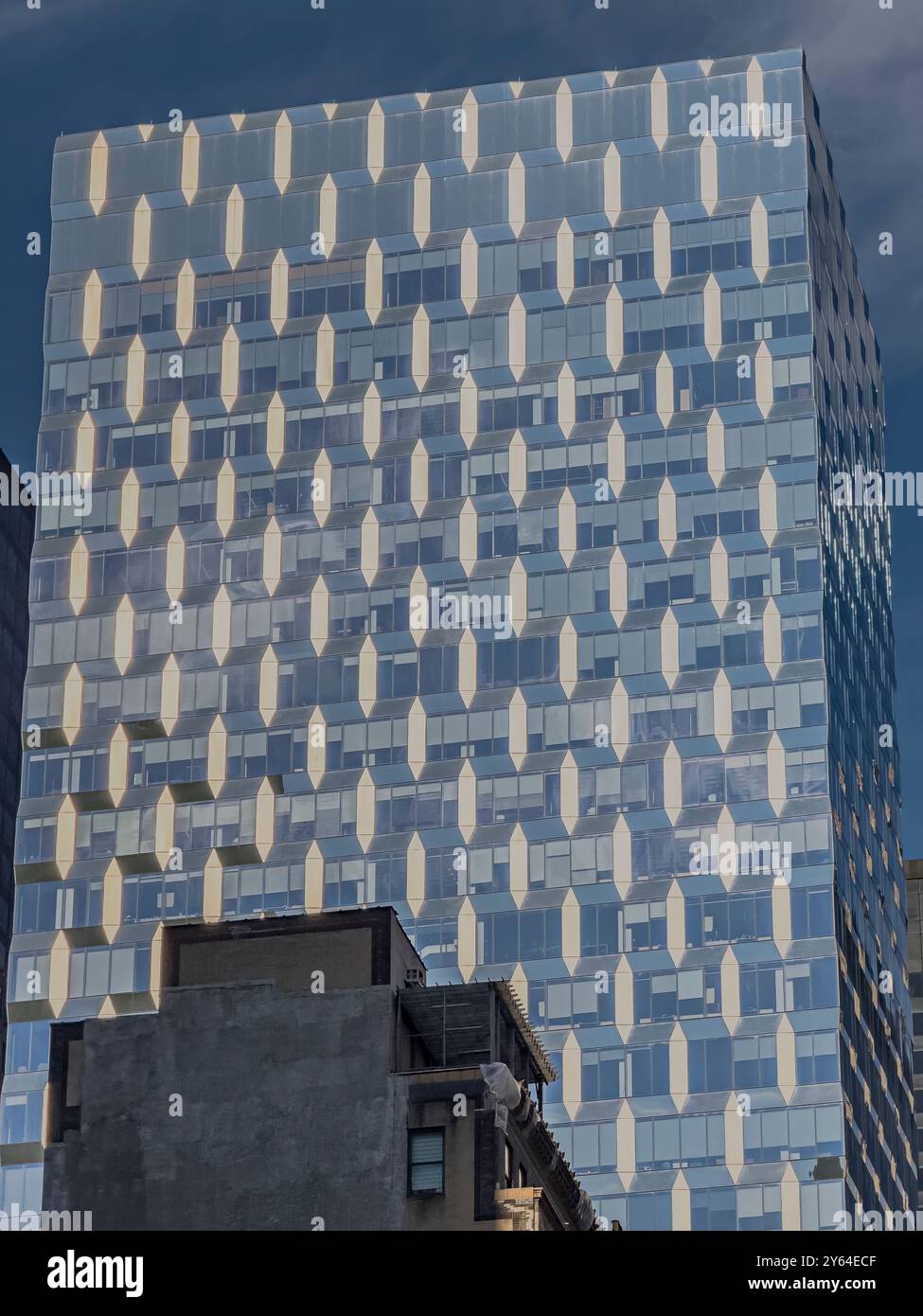 Modern high-rise building with a unique patterned glass facade in an ...